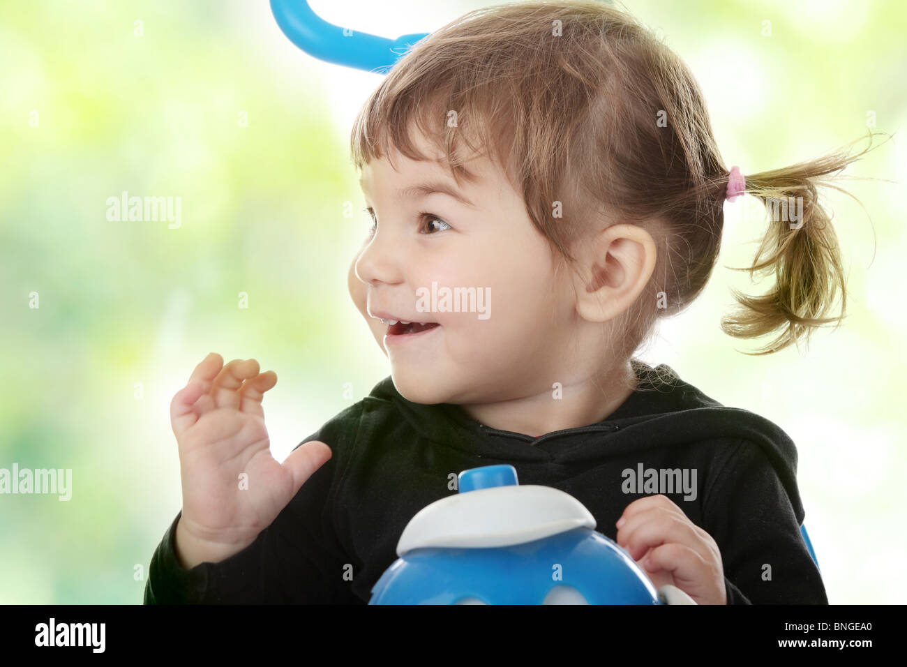 Portrait of a 2 year old girl against abstract green background Stock ...