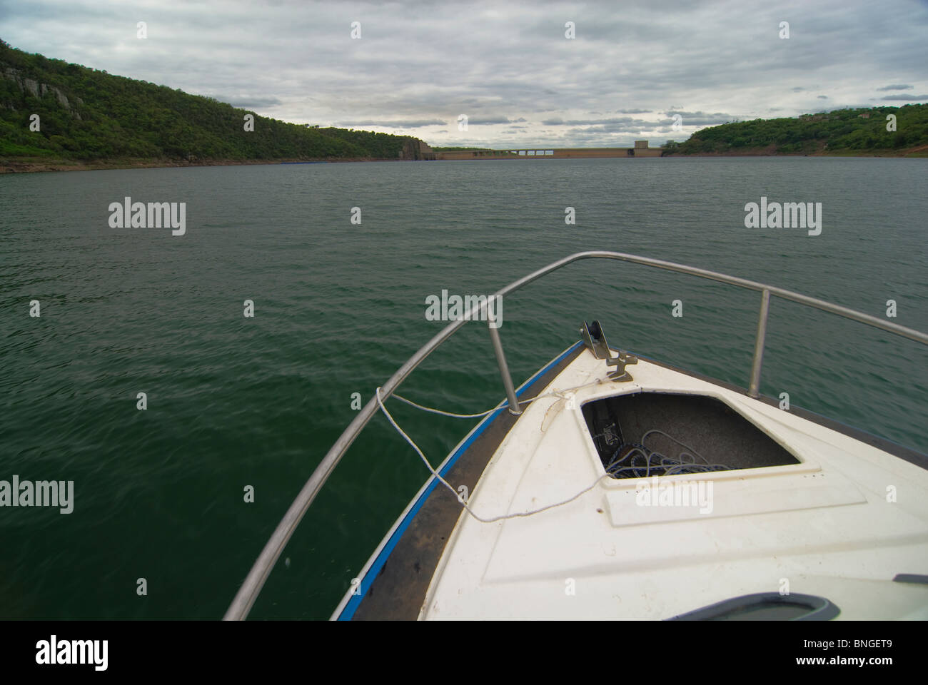 High angle of a boats bow surrounded by water. Two pieces of land ...