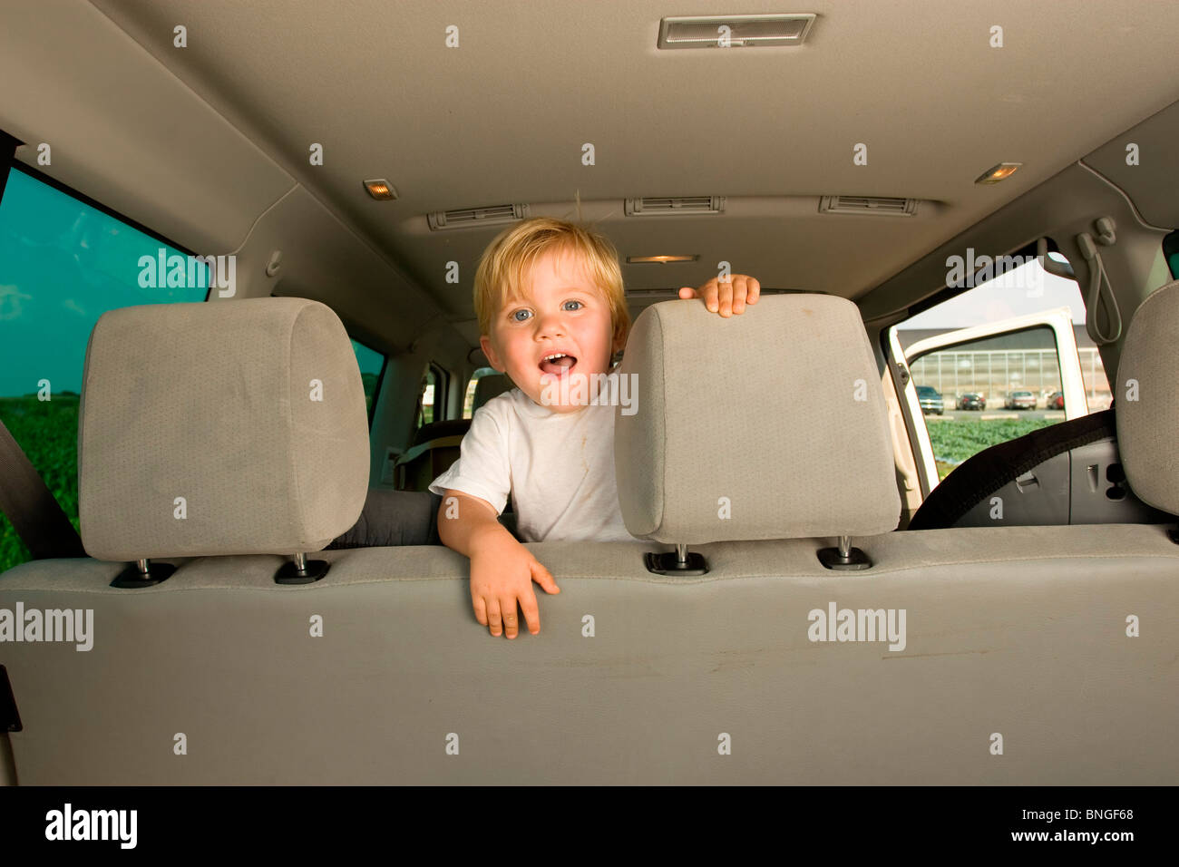 Baby boy playing in a mini van Stock Photo - Alamy