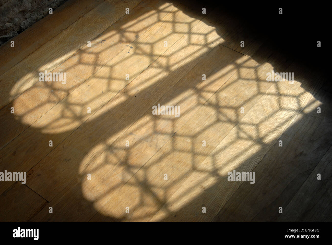 Sunlight through medieval leaded windows casts shadows and patterns on ...
