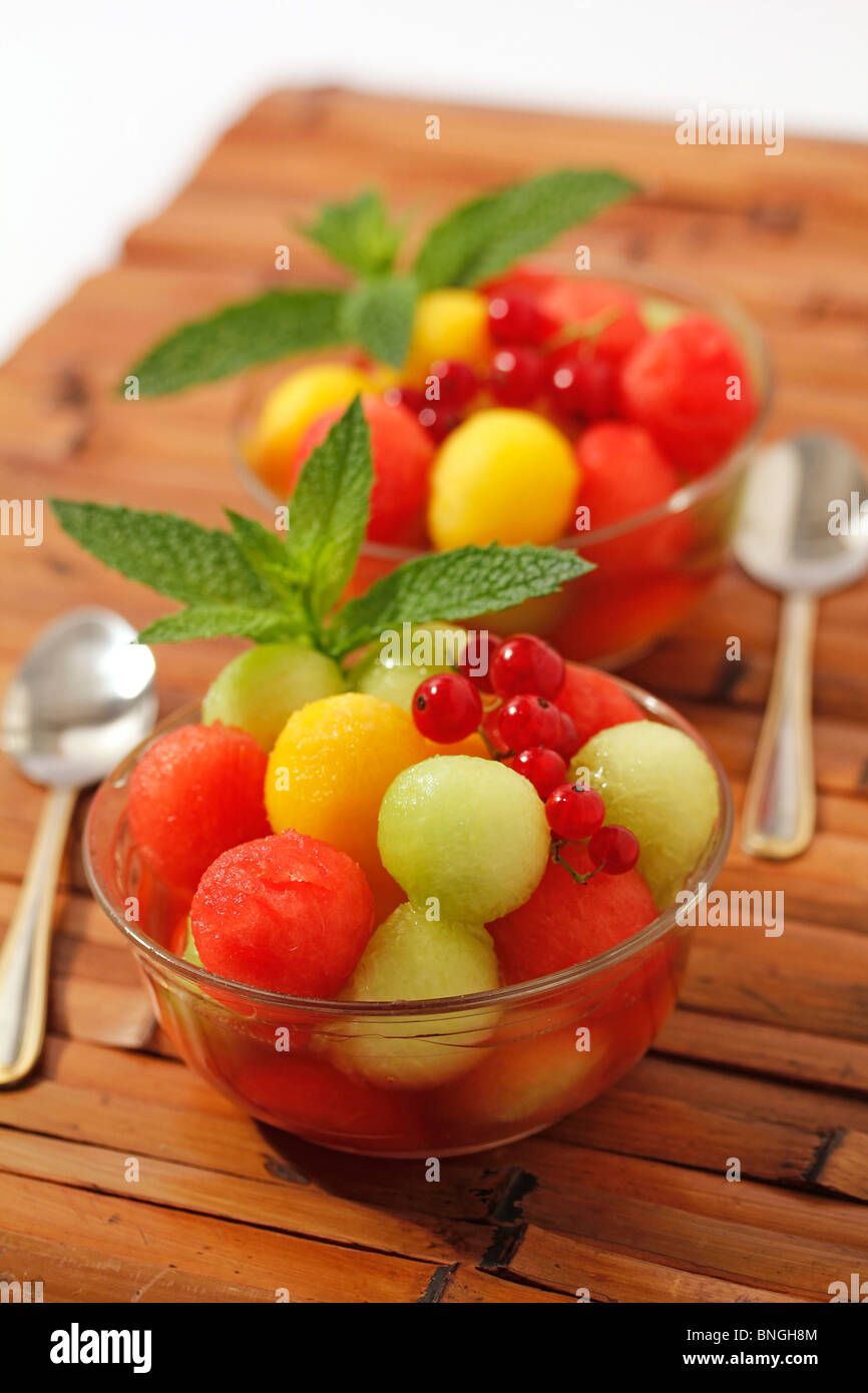 Fruit balls with red currants coulis. Recipe available Stock Photo - Alamy