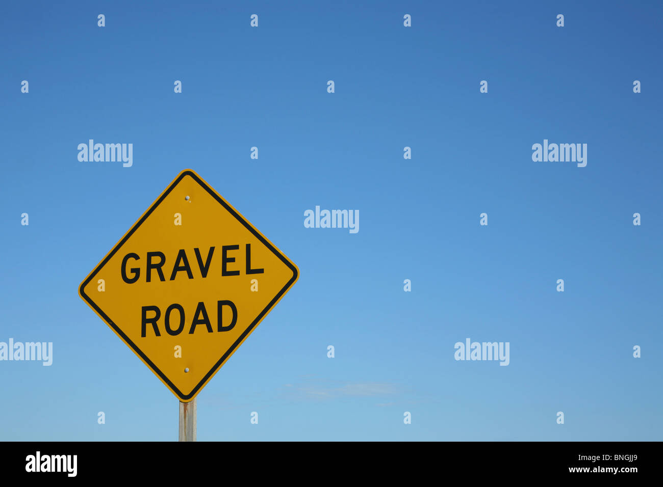 Close-up of a Gravel Road warning sign Stock Photo - Alamy