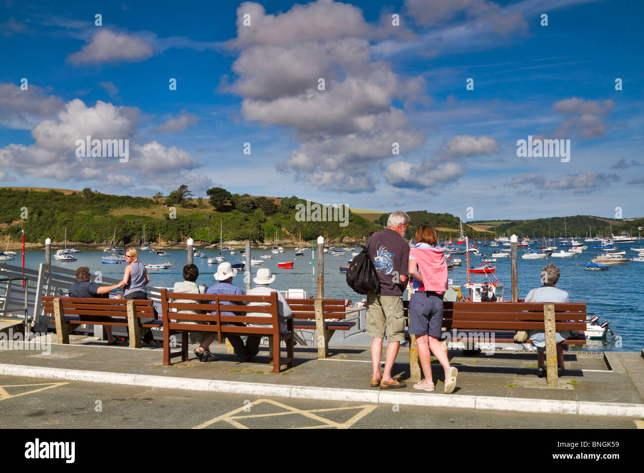 Tourists enjoy the sun and views of Kingsbridge Estuary from the ...