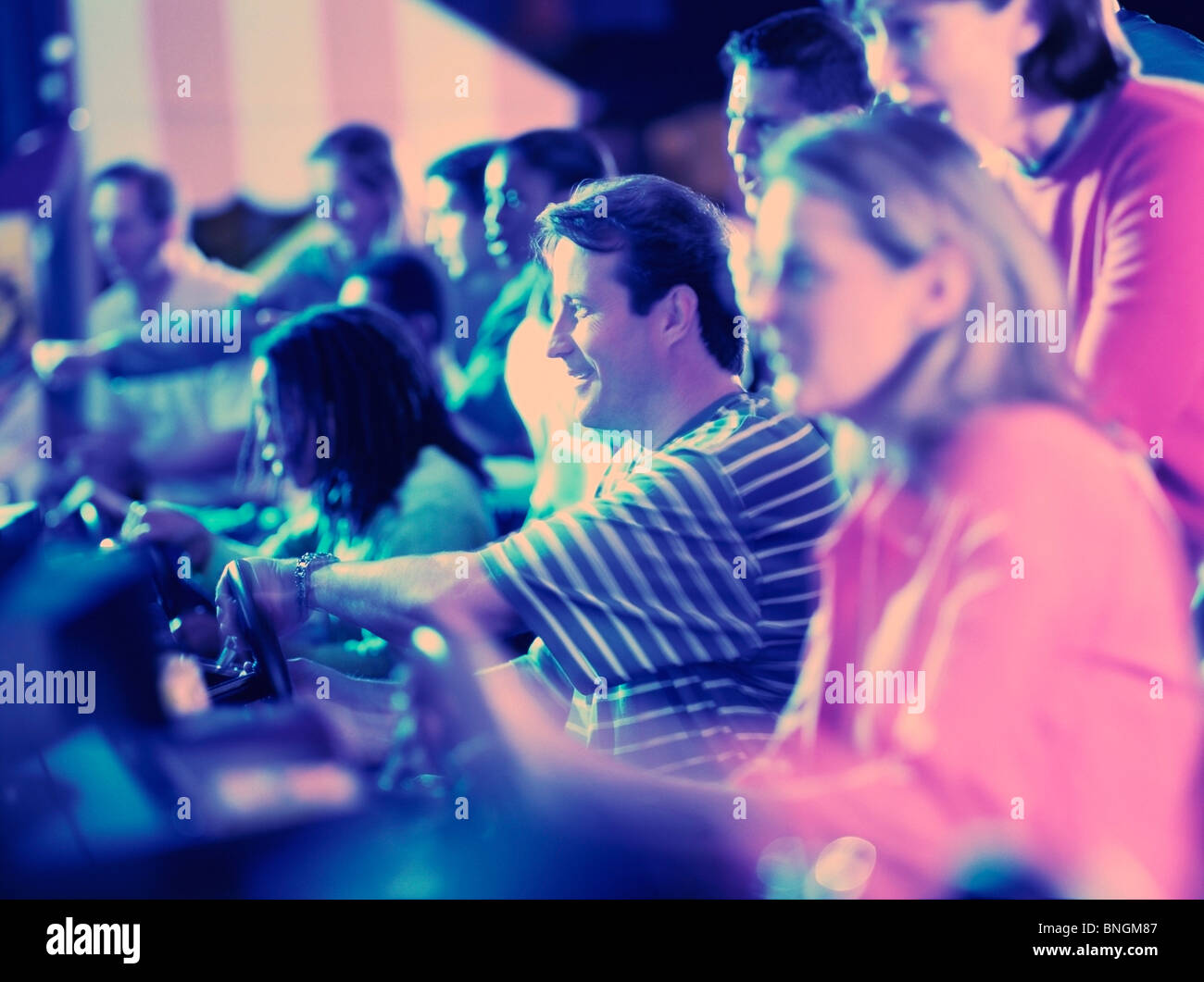 People playing video games in an amusement arcade Stock Photo - Alamy