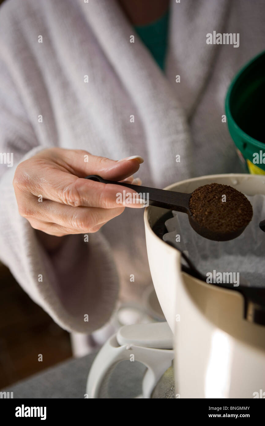 Senior woman filling a coffee maker with coffee Stock Photo - Alamy