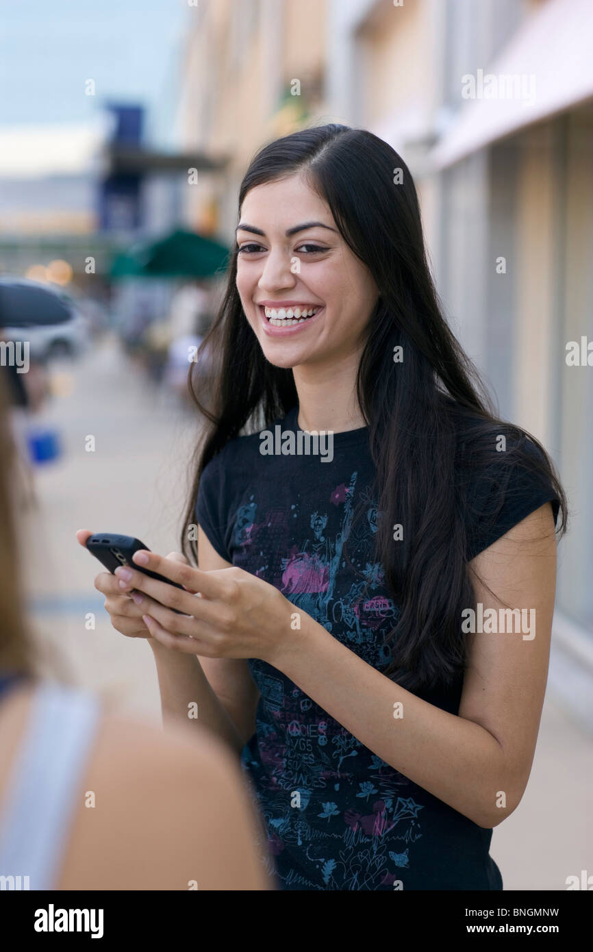 Young woman text messaging on a mobile phone Stock Photo - Alamy