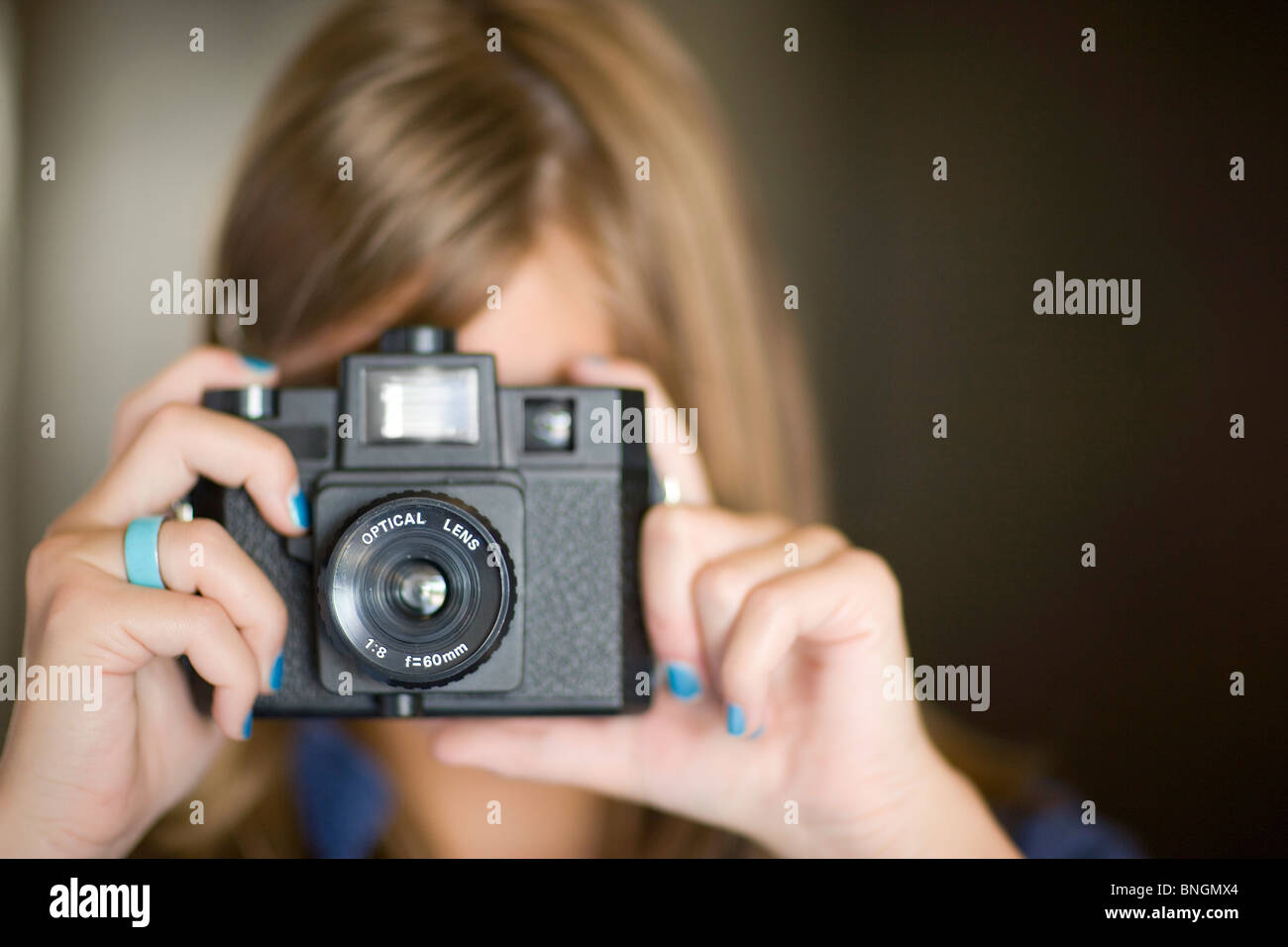 Teenage girl taking a picture with a camera Stock Photo - Alamy