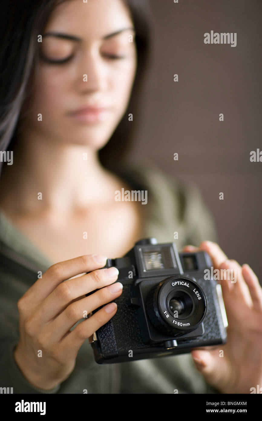 Young woman taking a picture with a camera Stock Photo - Alamy