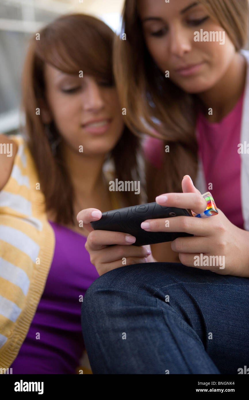 Young women using mobile phone Stock Photo - Alamy
