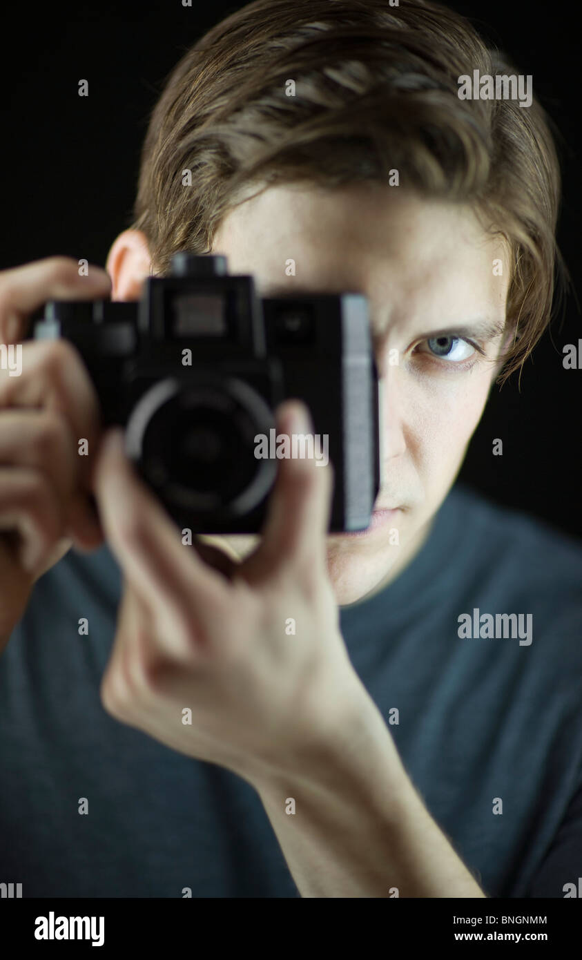 Young Photographer holding camera Stock Photo - Alamy