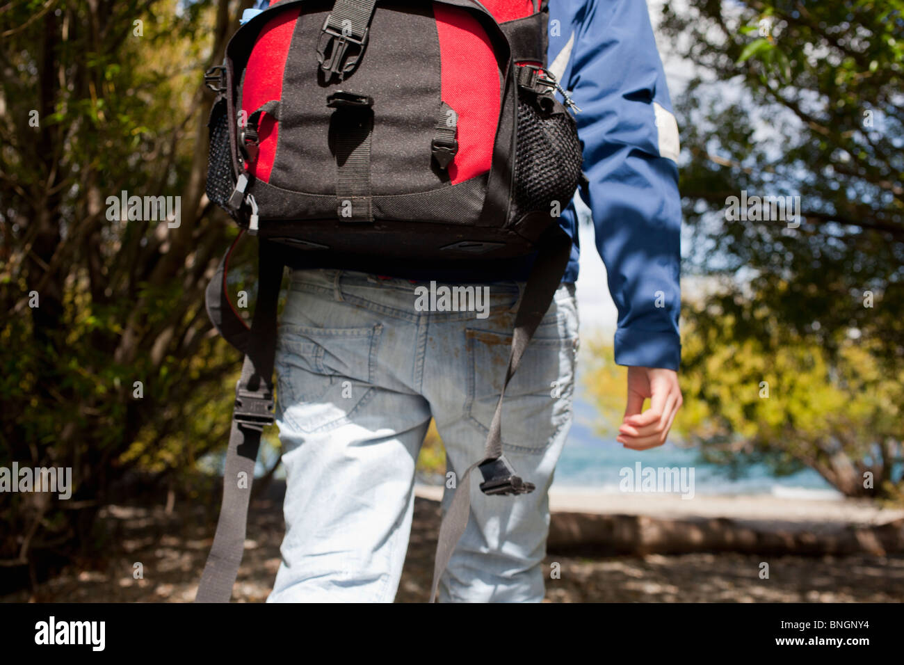 Traveller walking with a backpack Stock Photo - Alamy