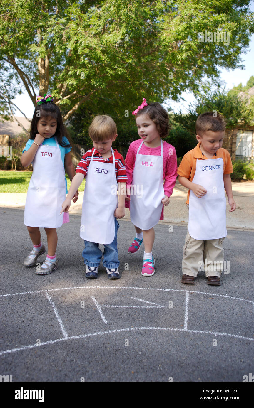 Four kids getting ready to play Stock Photo - Alamy