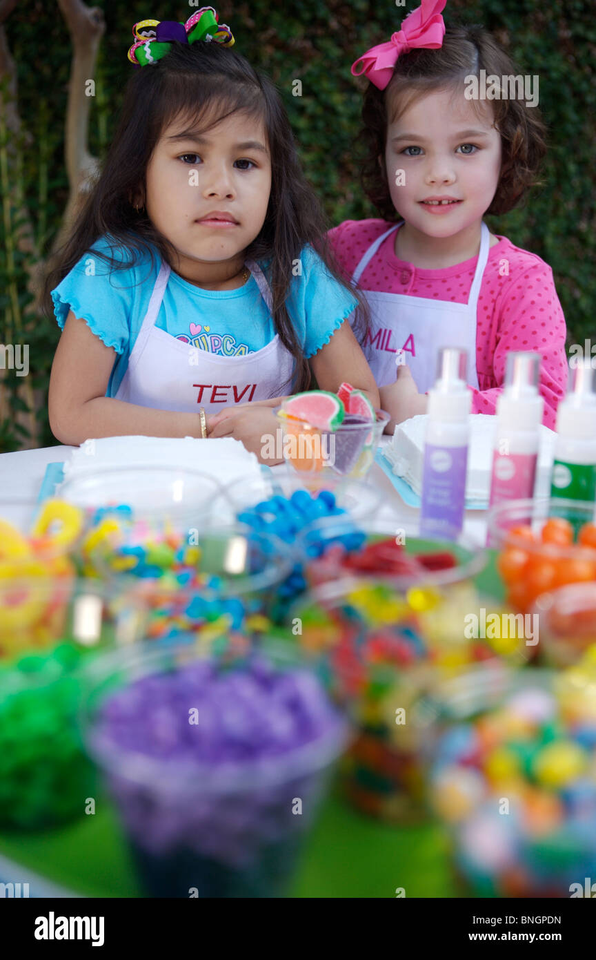 Two girls decorating birthday cakes Stock Photo - Alamy