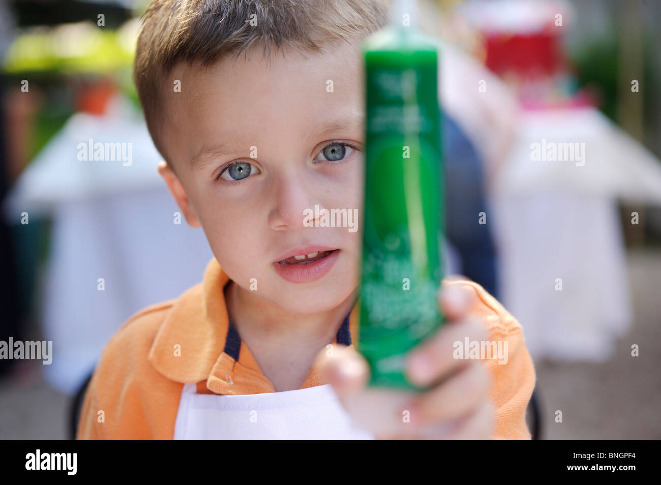 Young boy teaching how to put icing on cake Stock Photo - Alamy