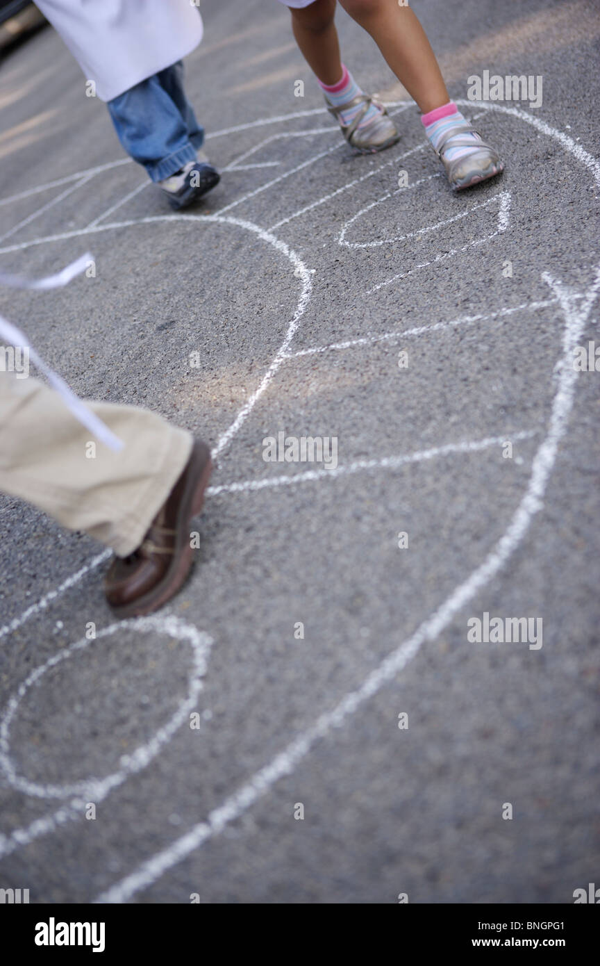 Kids legs and feet walking and playing street game Stock Photo - Alamy