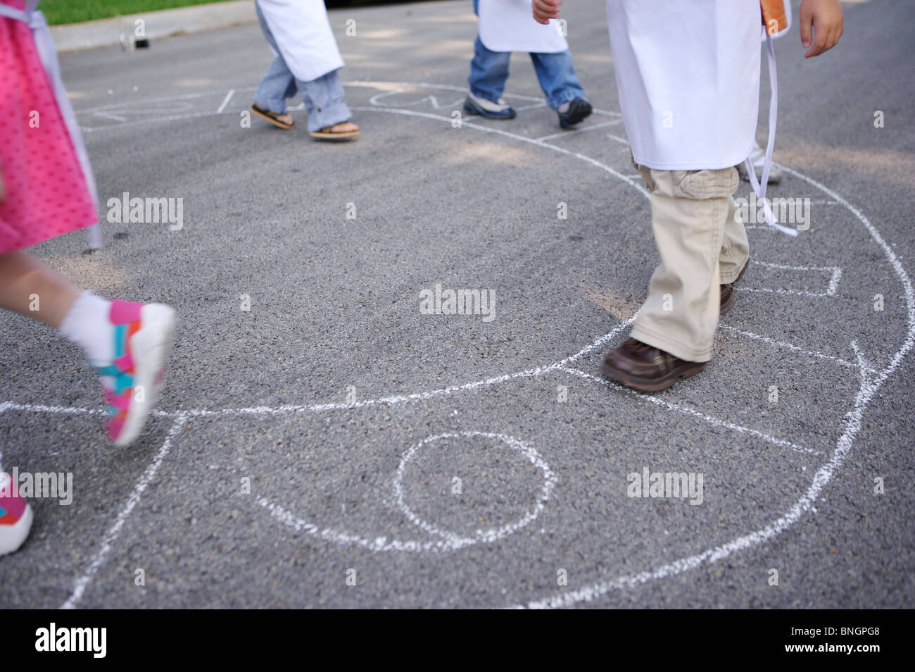 Kids legs and feet walking and playing street game Stock Photo - Alamy