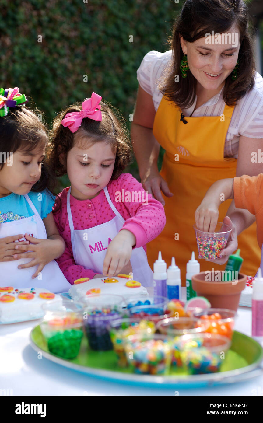 Mother helping boys and girls have fun at party Stock Photo - Alamy