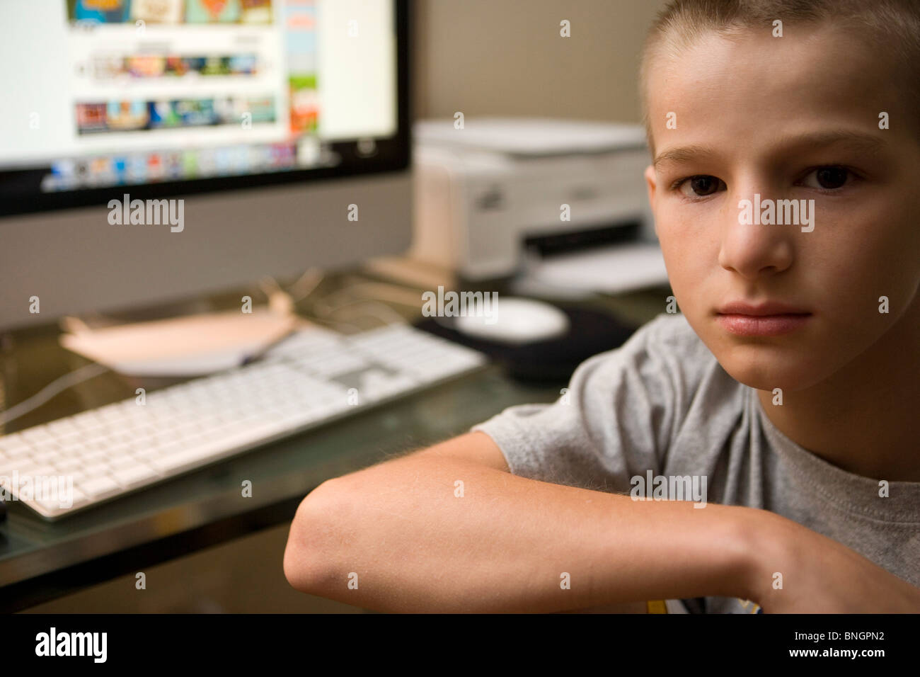 Portrait of a boy near a computer, USA Stock Photo - Alamy