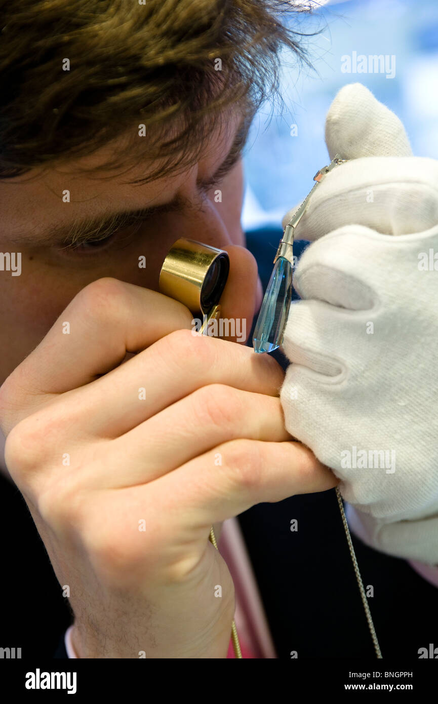 Jeweller inspects a diamond through a lupe Stock Photo - Alamy