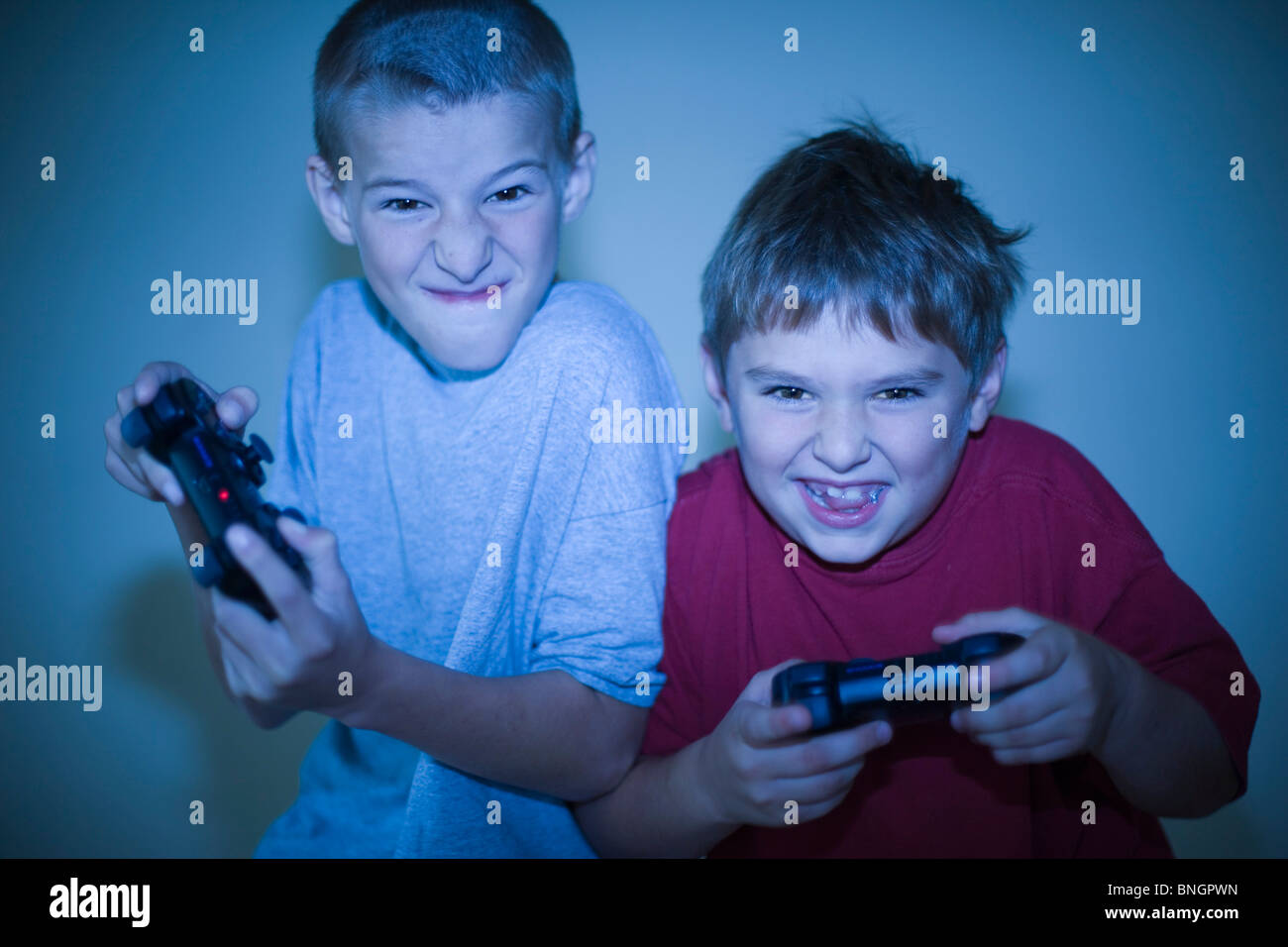 Two boys competing in a video game hi-res stock photography and images ...