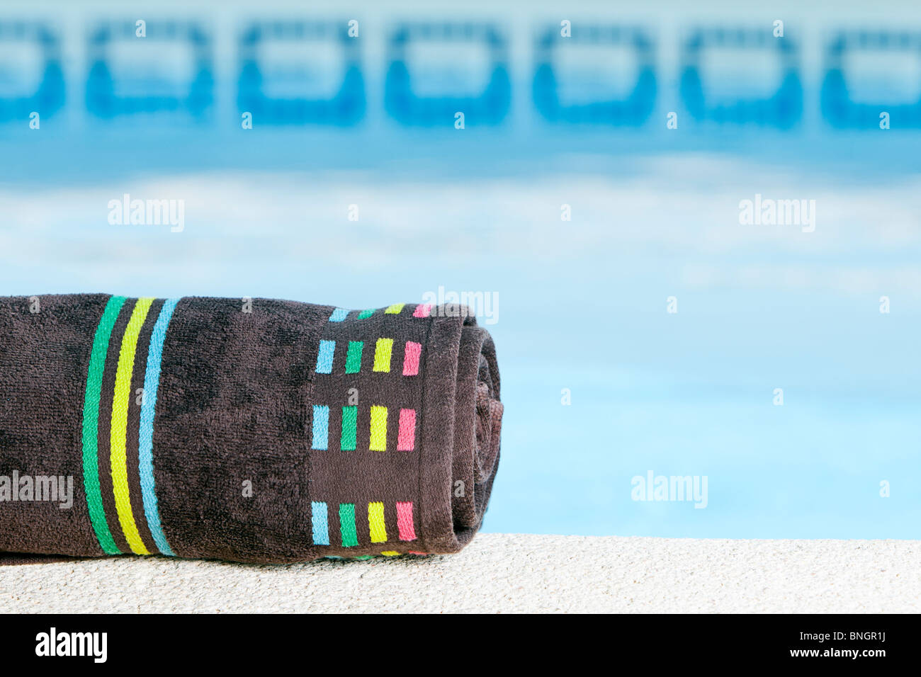 Shot of a Rolled Towel next to the Swimming Pool Stock Photo - Alamy