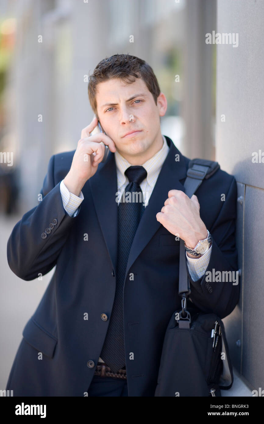 Businessman on cell phone outside Stock Photo - Alamy