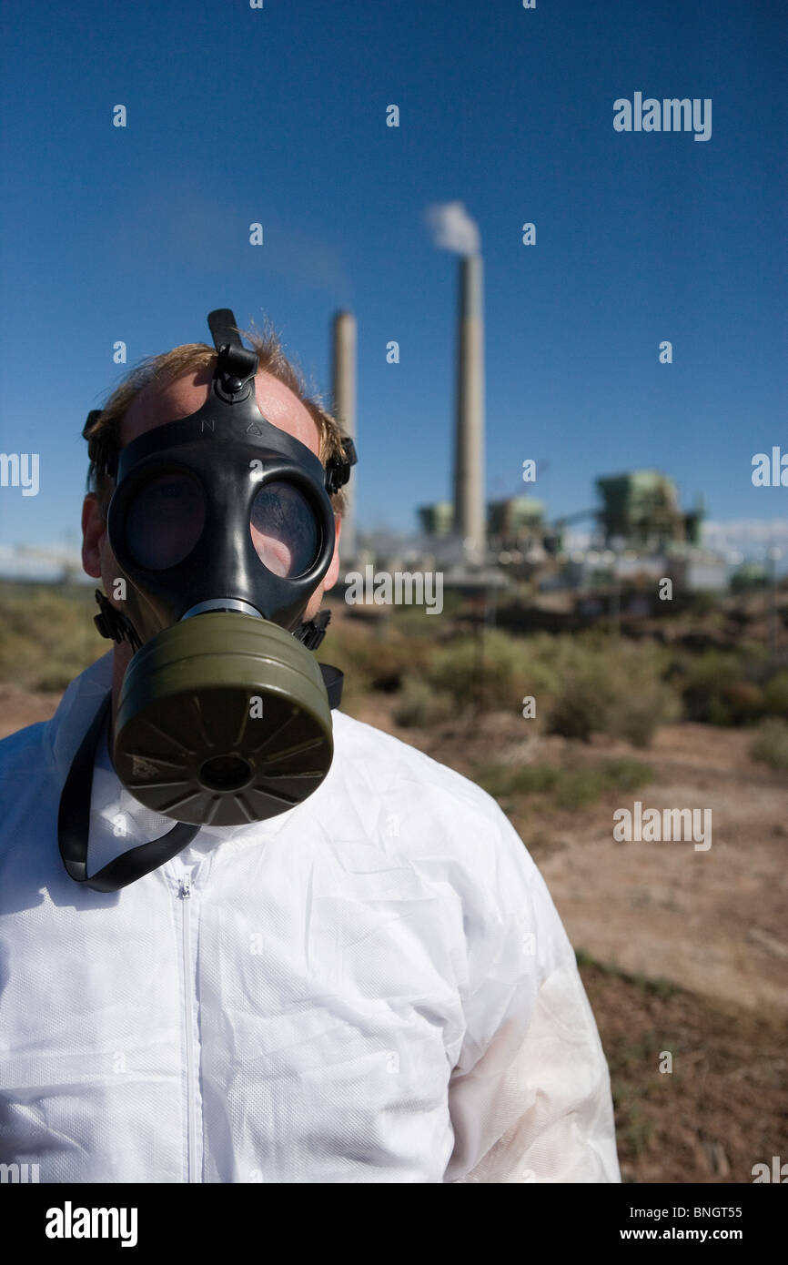 Man wearing gas mask in front of coal mine refinery Stock Photo - Alamy