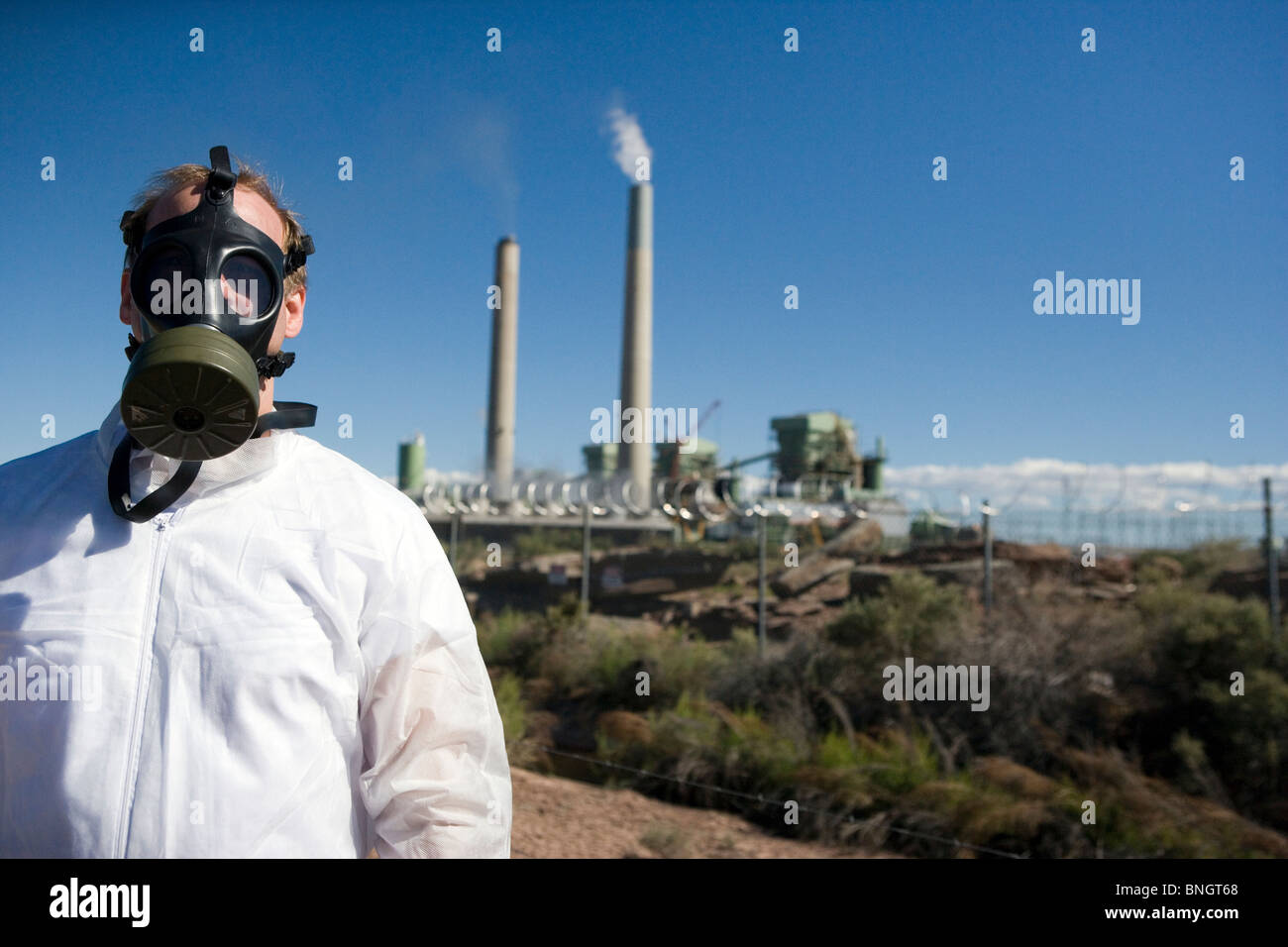 Man wearing gas mask in front of coal mine refinery Stock Photo - Alamy