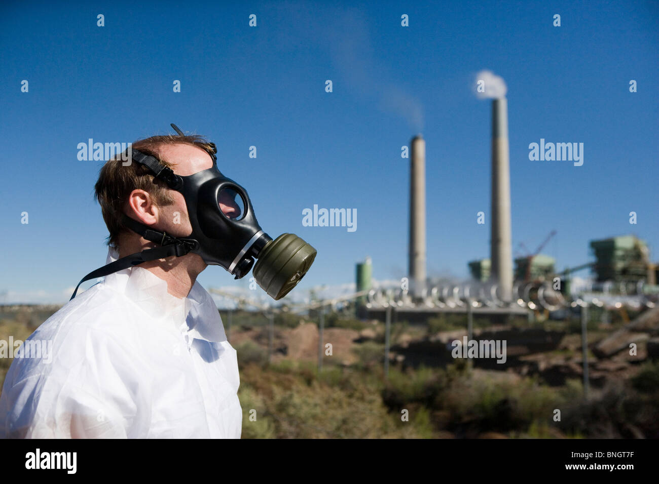 Man in gas mask in front of coal mine refinery Stock Photo - Alamy