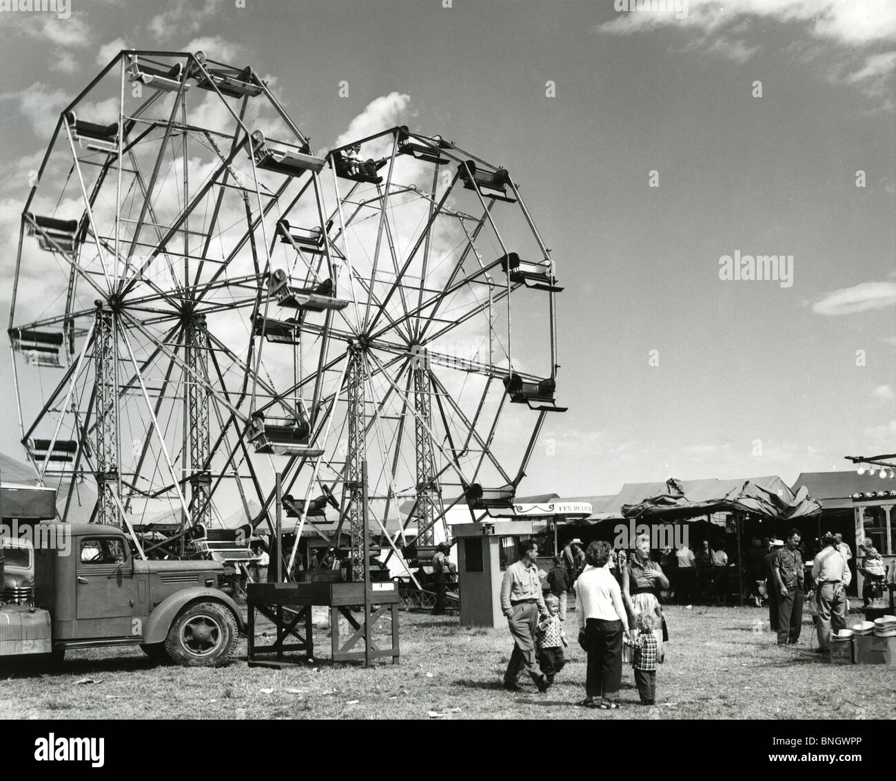 Two Ferris wheels in amusement park, 1950s Stock Photo - Alamy