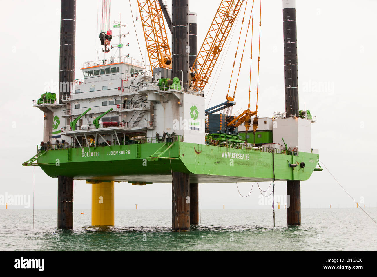 A jack up barge fitting wind turbines into the sea bed at the Walney ...