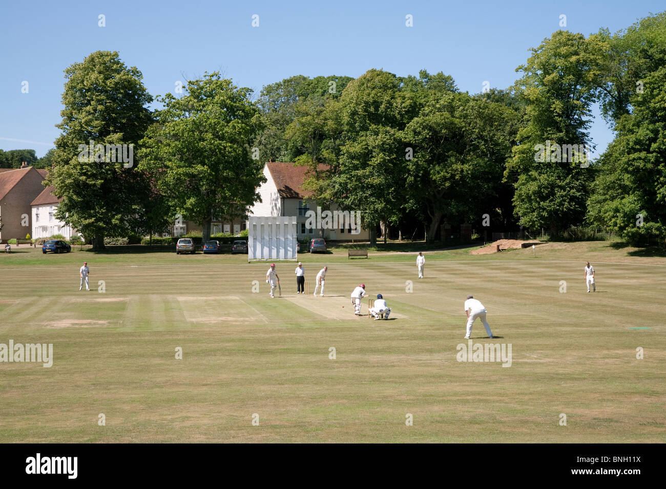 A weekend game of cricket in the english village of Lyminge, Kent, UK ...