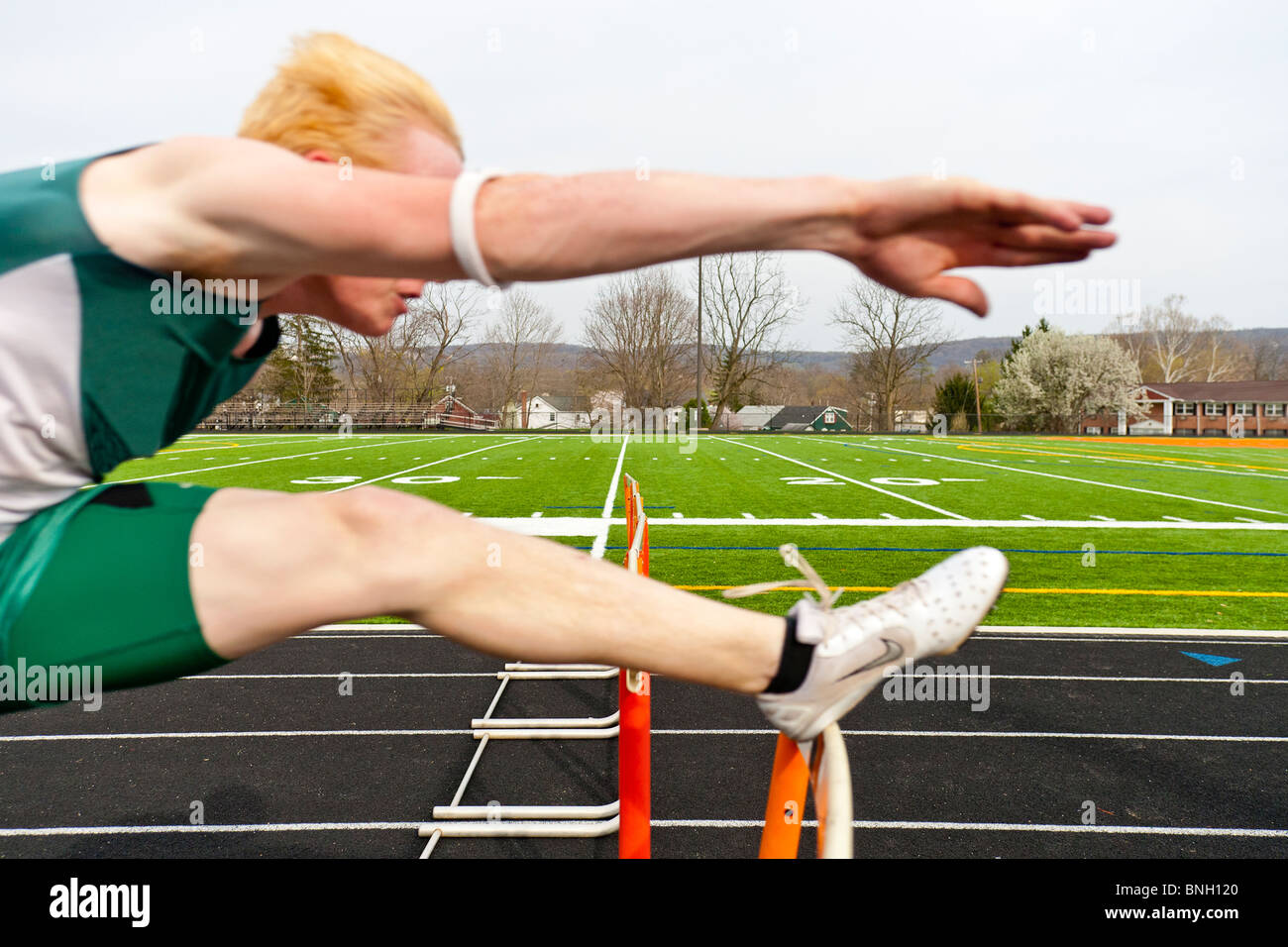 A runner jumping the hurdle during a Track and Field competition Stock ...