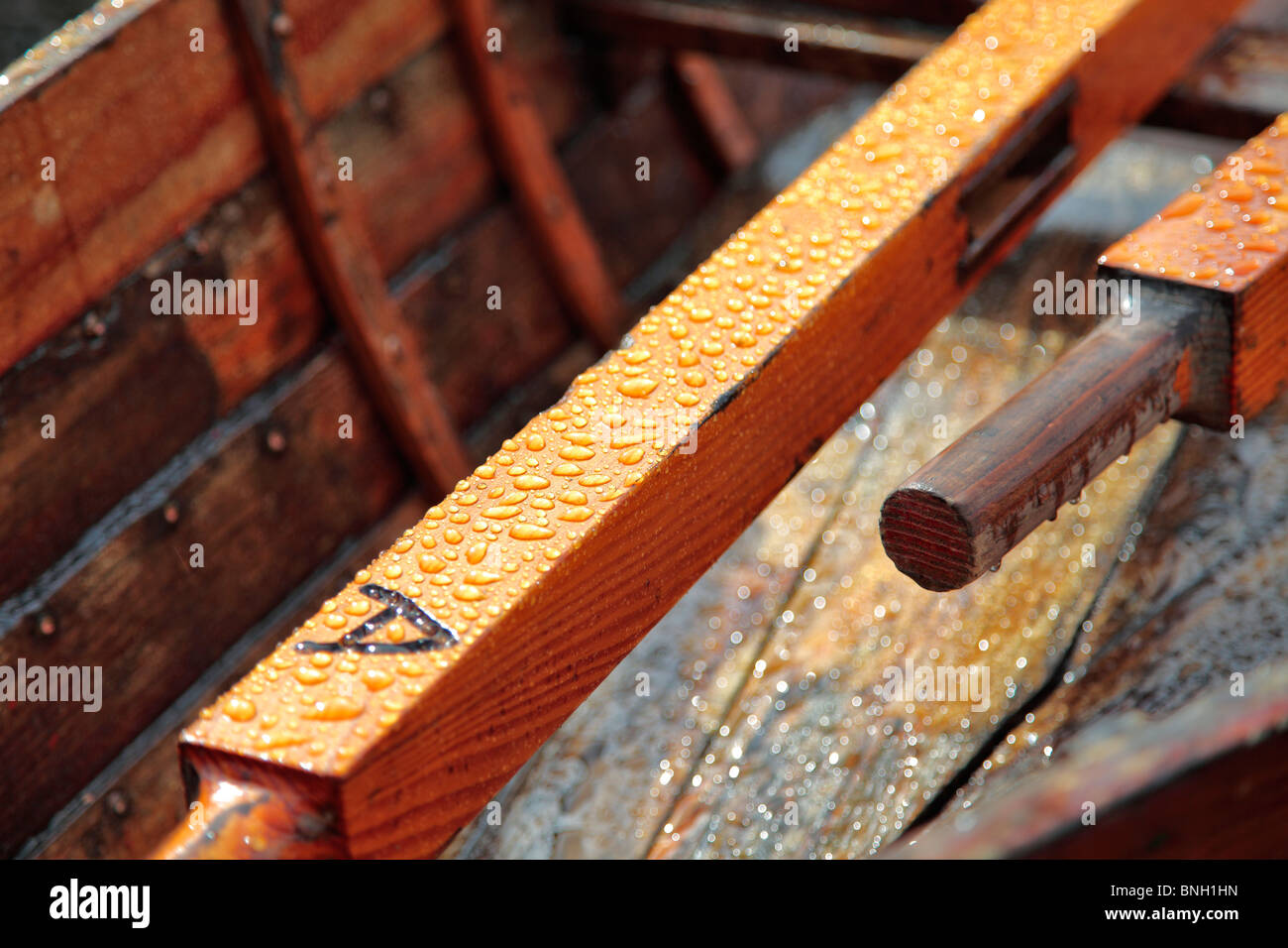 The rain soaked oars of a wooden rowing boat Stock Photo - Alamy