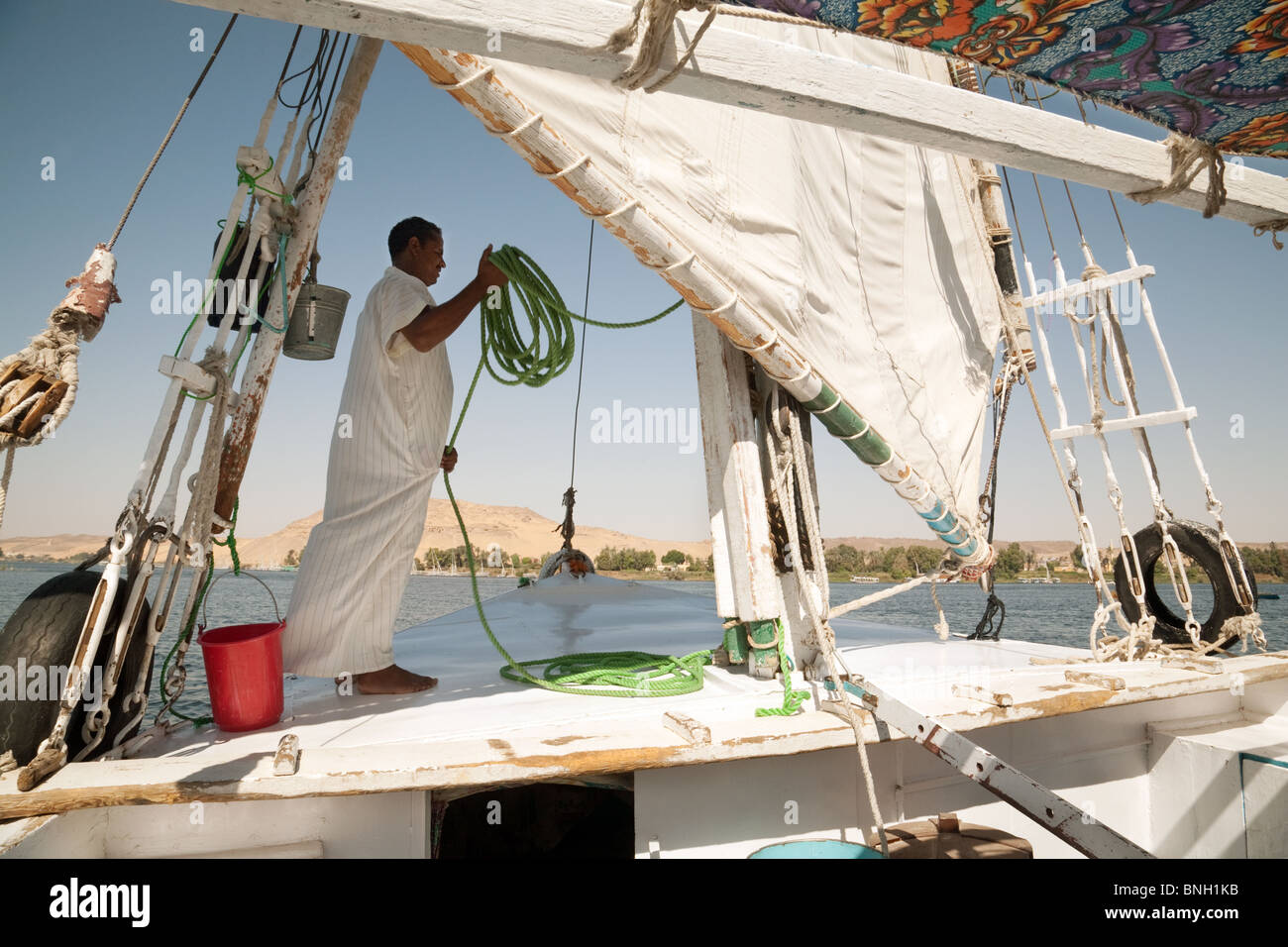 An egyptian sailor on his felucca, River Nile at Aswan, Upper Egypt ...