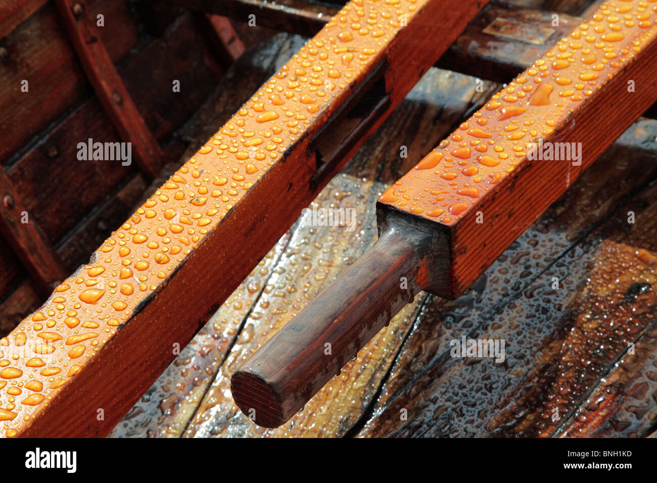 The rain soaked oars of a wooden rowing boat Stock Photo - Alamy