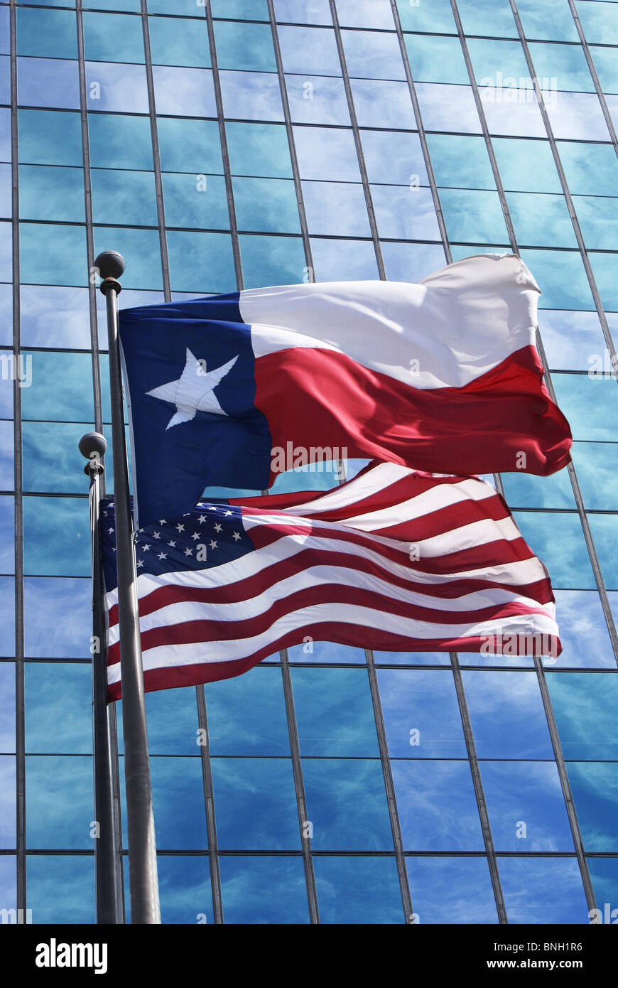 Flags against glass windows on building Stock Photo - Alamy