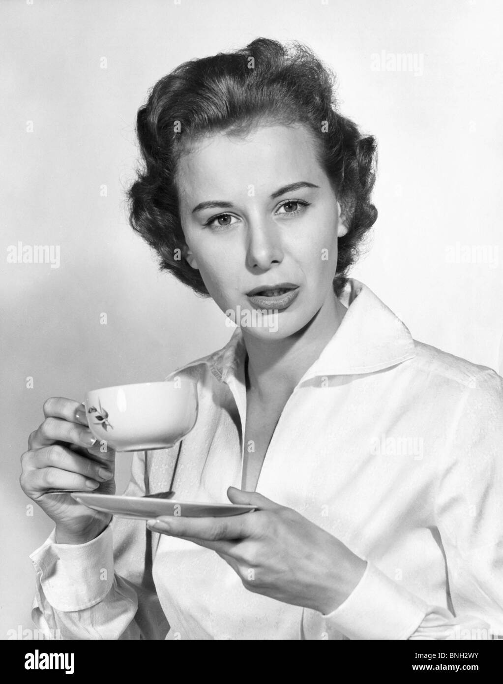 Portrait of a young woman holding a tea cup Stock Photo - Alamy