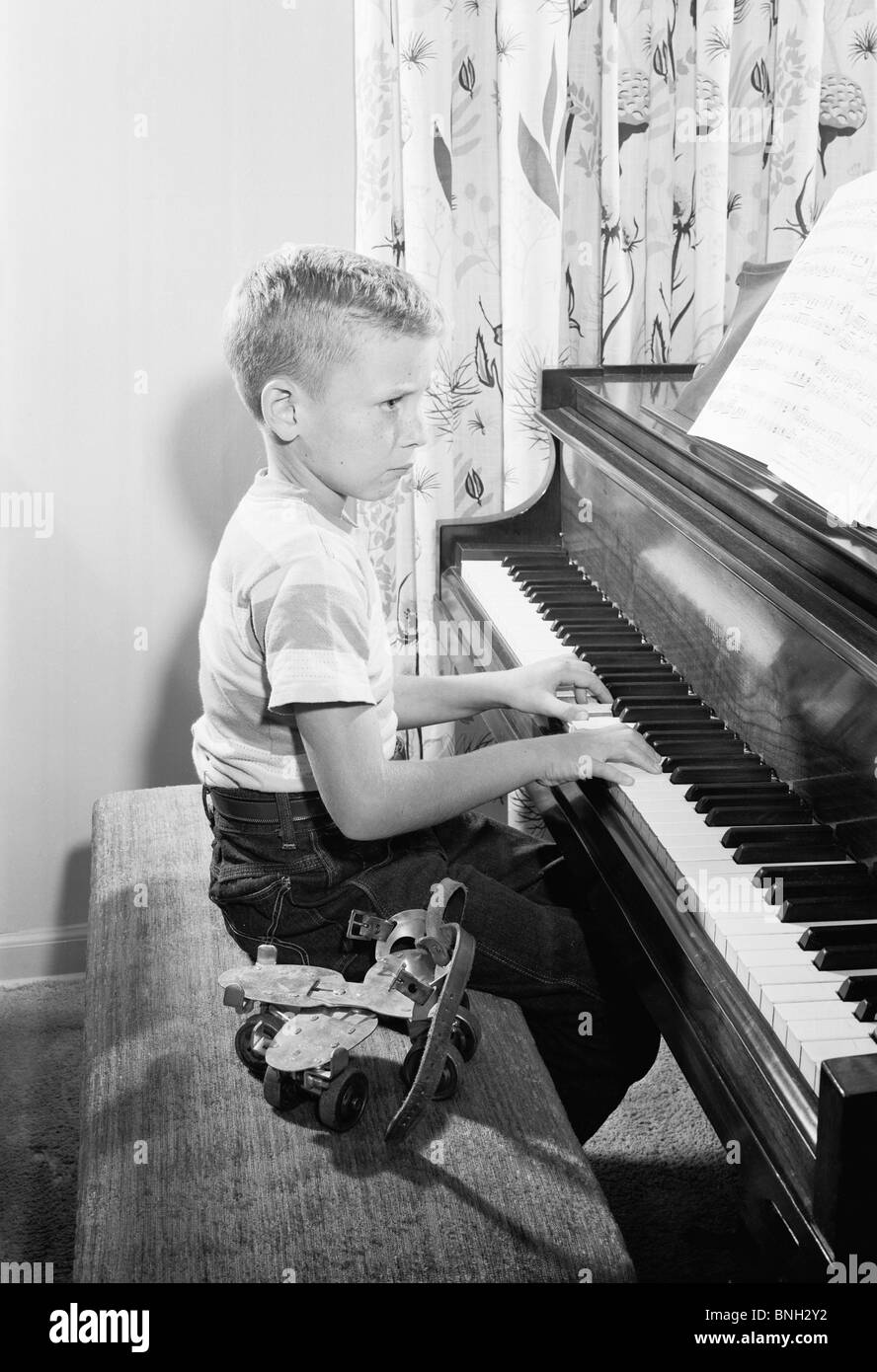 Side profile of boy playing piano Stock Photo - Alamy
