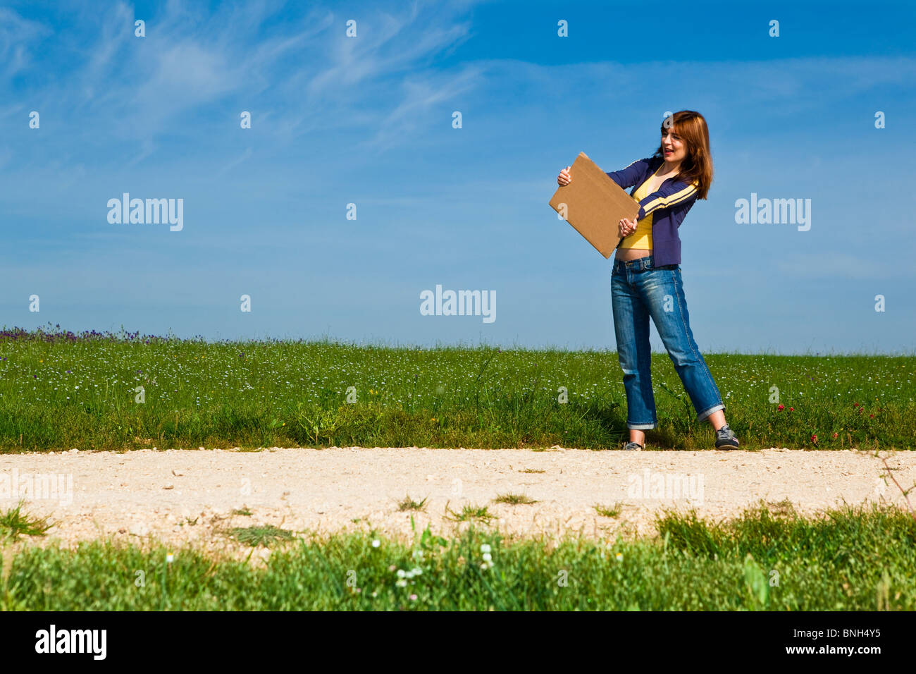 Young woman hitch hiking hi-res stock photography and images - Alamy