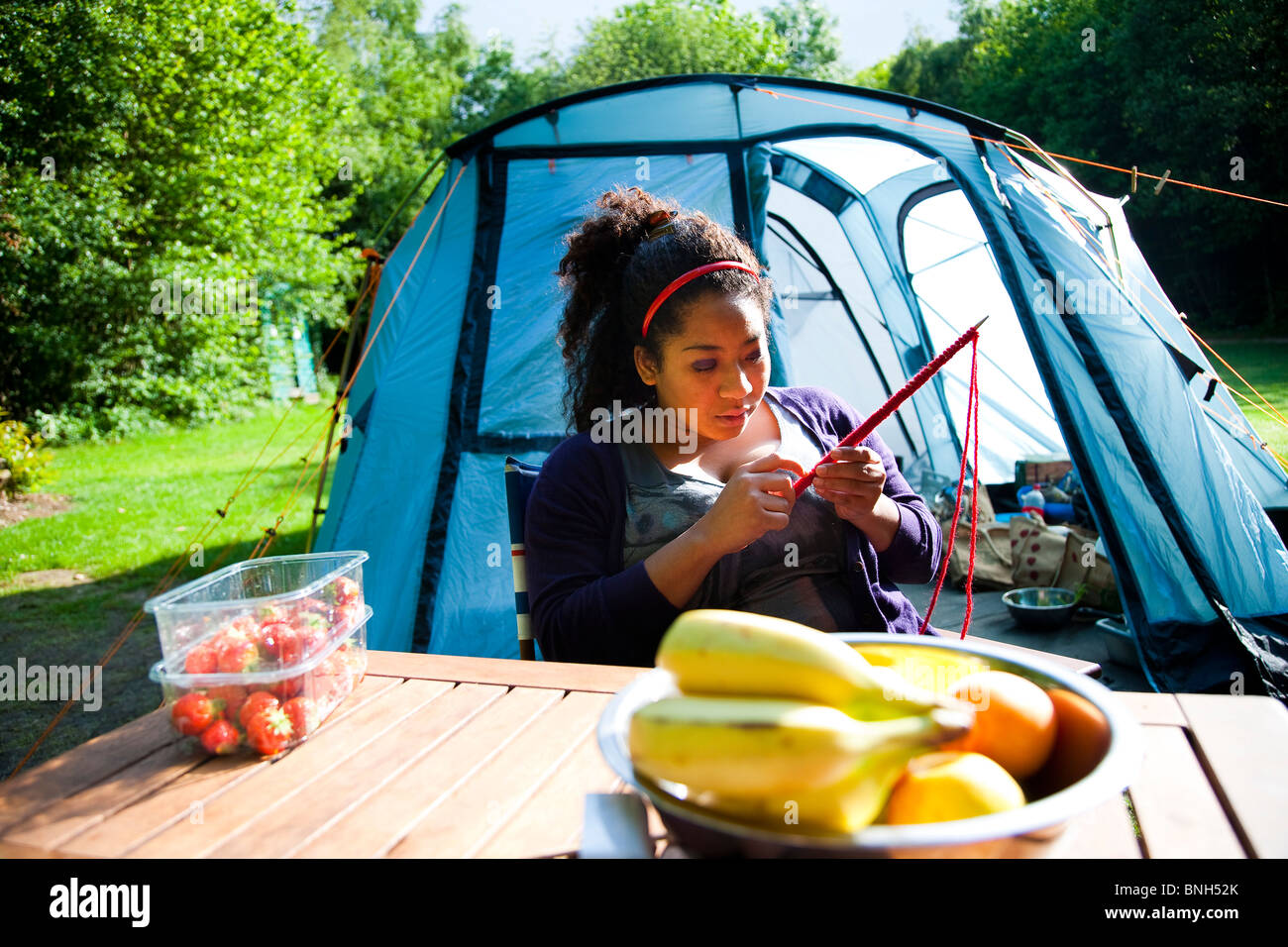 Woman knitting when camping in Kent Stock Photo - Alamy