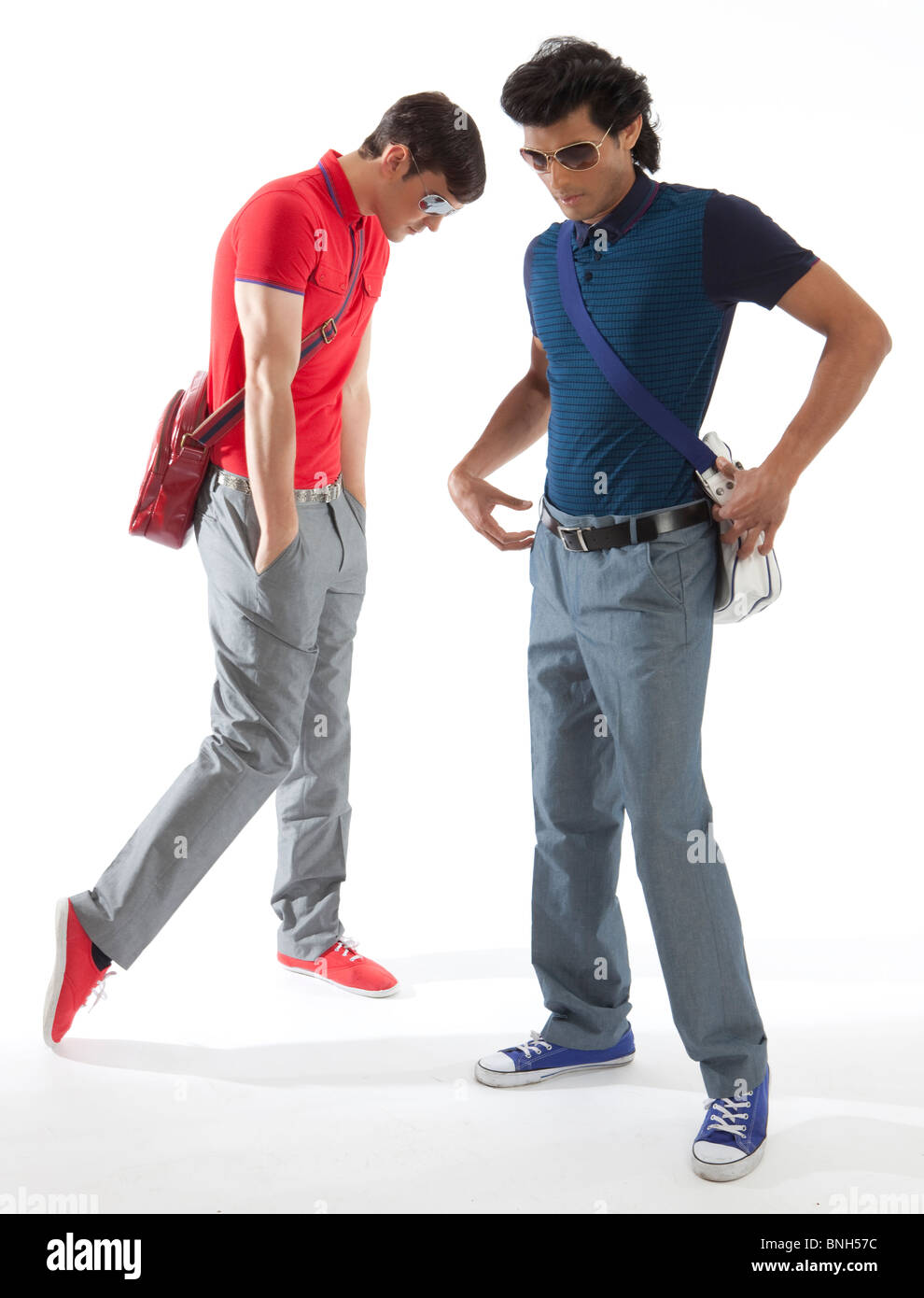 Two young men on white background Stock Photo - Alamy