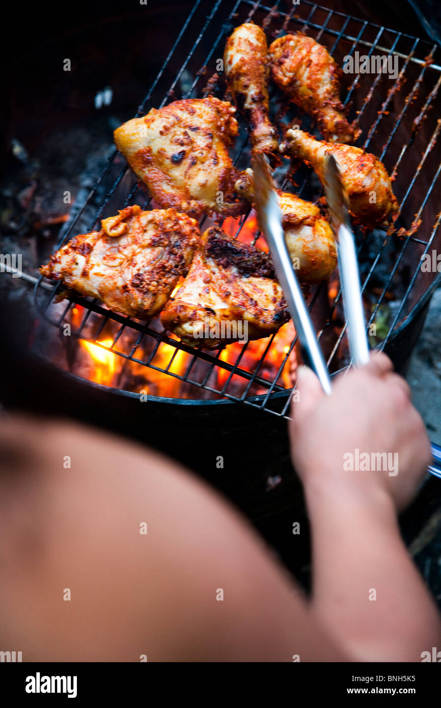 Cooking over open camp fire in Kent. Barbeque chicken Stock Photo - Alamy