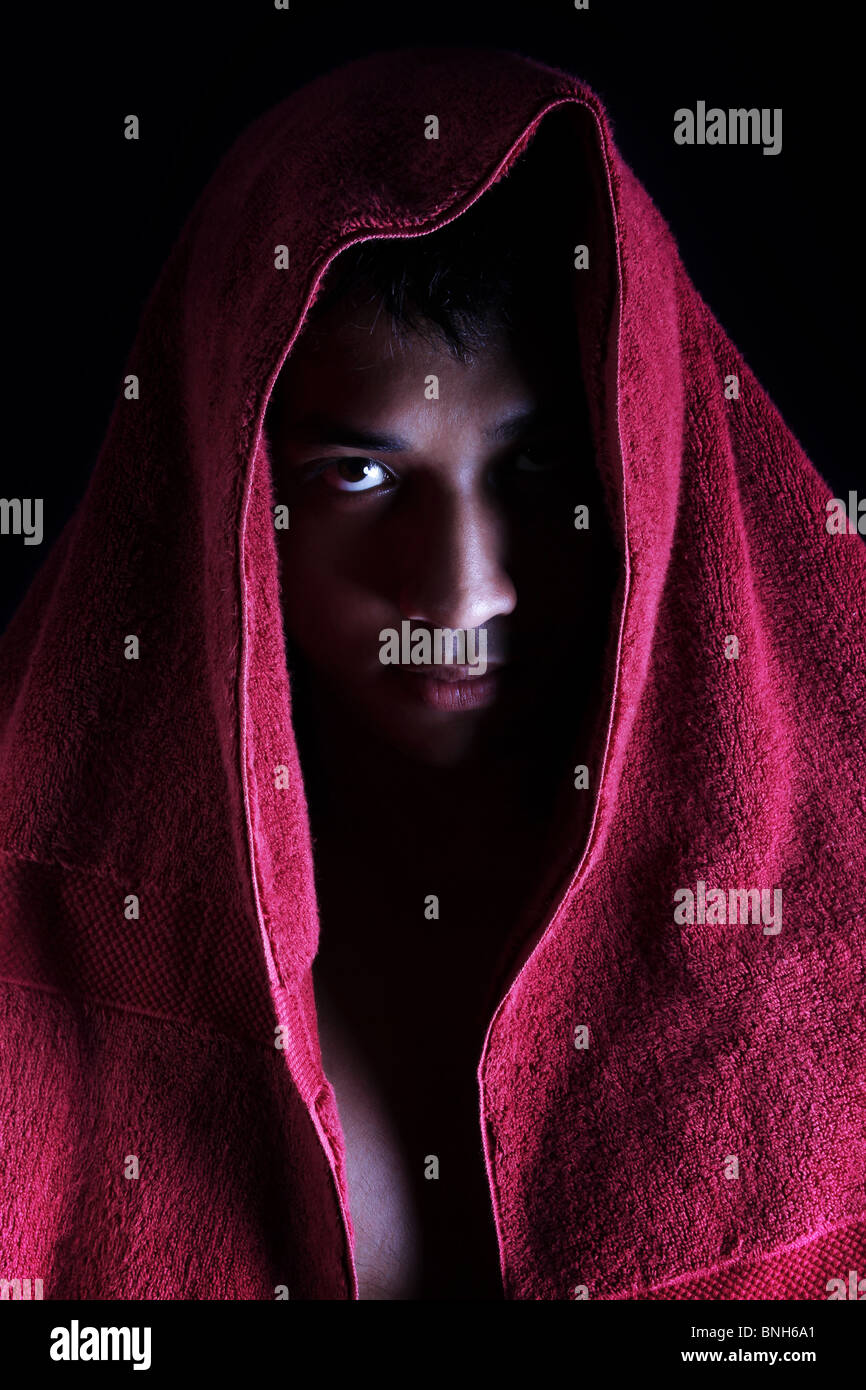 male head covered with maroon towel Stock Photo - Alamy