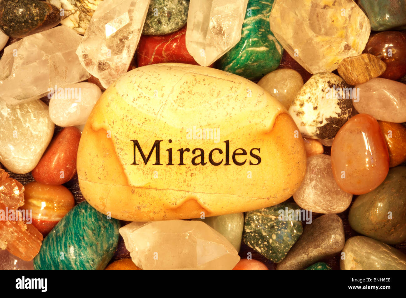 Stones and Crystals with a rock with word miracles Stock Photo - Alamy