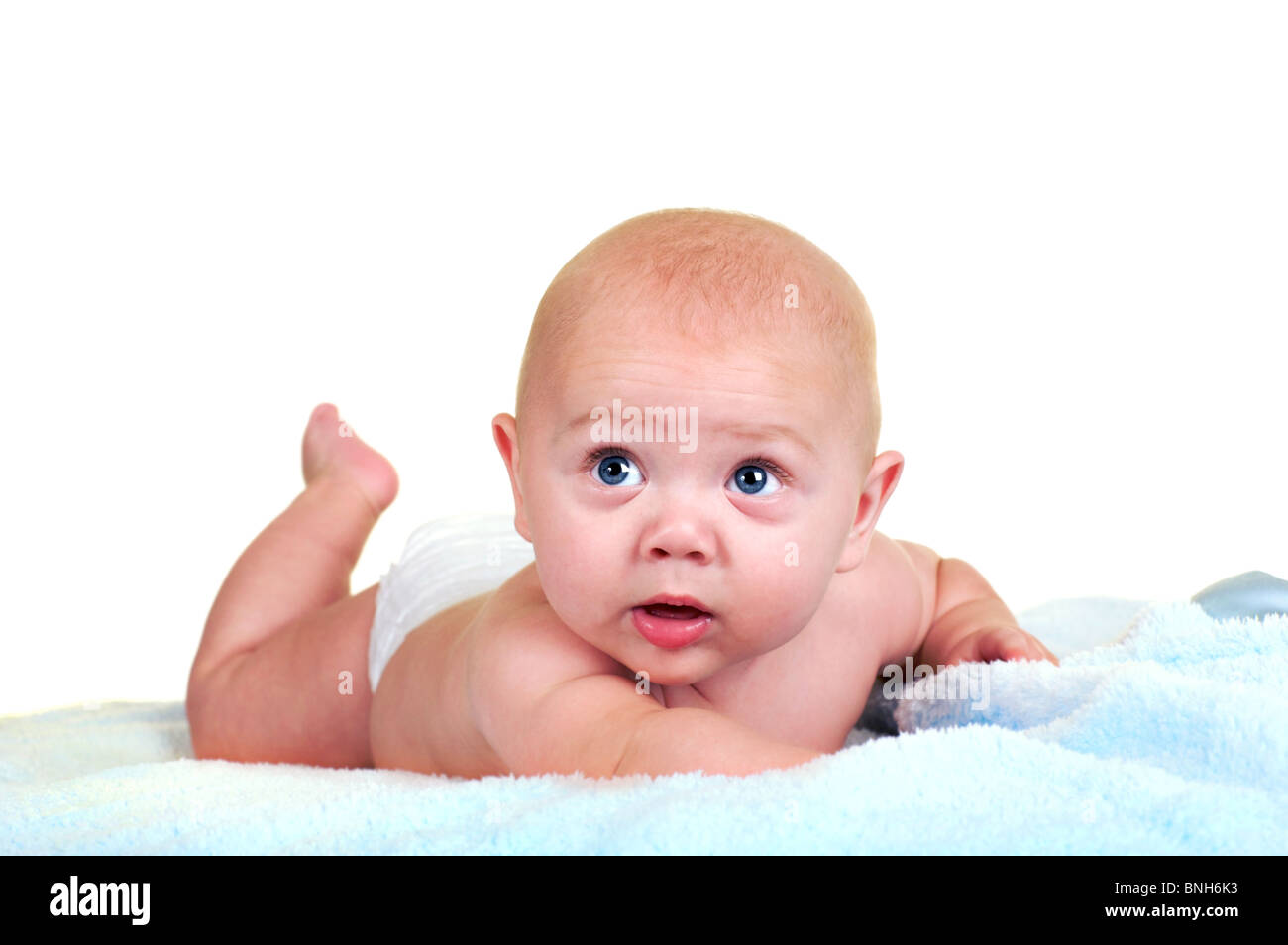 Sweet little baby on blue blanket looking upward Stock Photo - Alamy