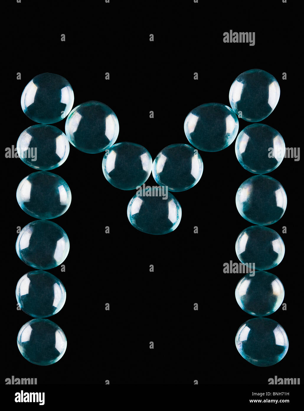 Close-up of marble balls arranged in the shape of letter M Stock Photo ...