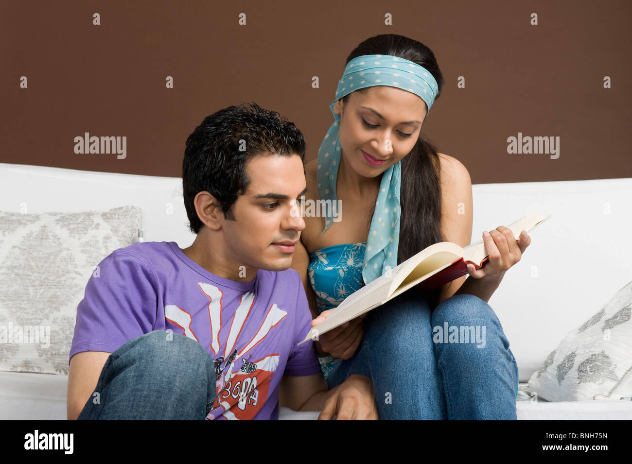 Couple reading a book together Stock Photo - Alamy