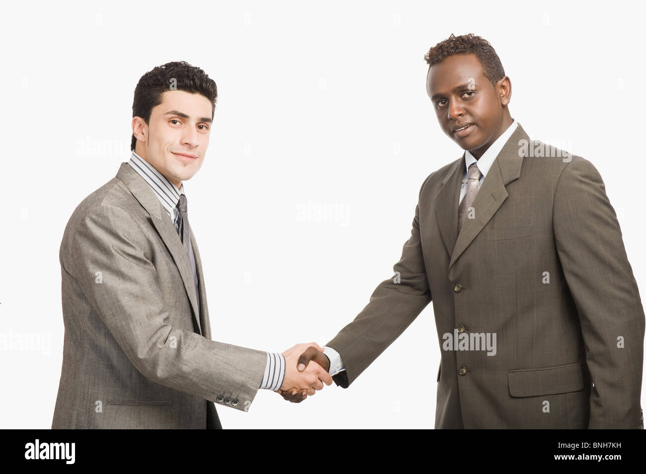 Two businessmen shaking hands Stock Photo - Alamy
