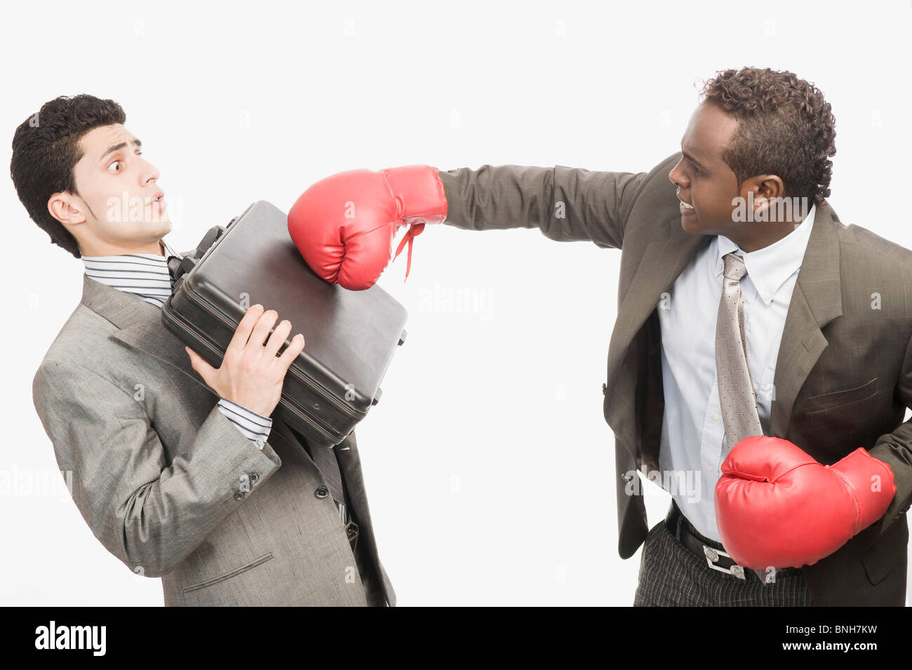 Businessman defending himself from the punch of his colleague Stock ...